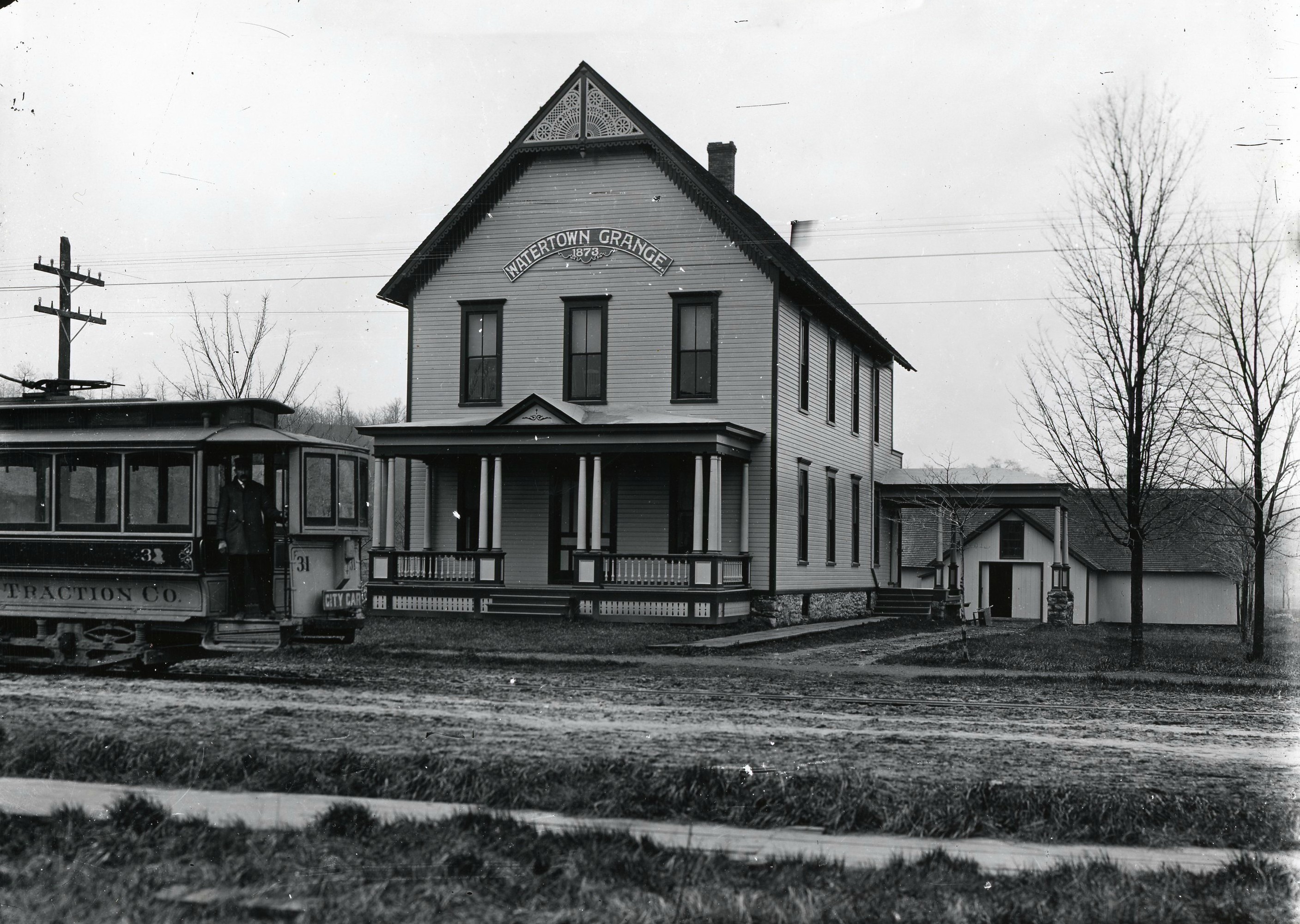 Trolley and trolleyman on State Street in Watertown