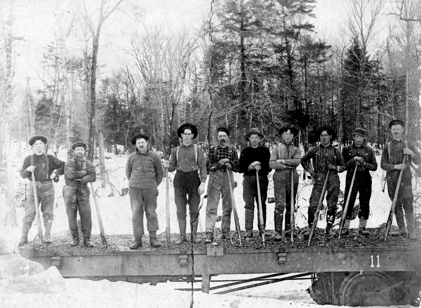 Loggers on a railroad log car in Benson Mines