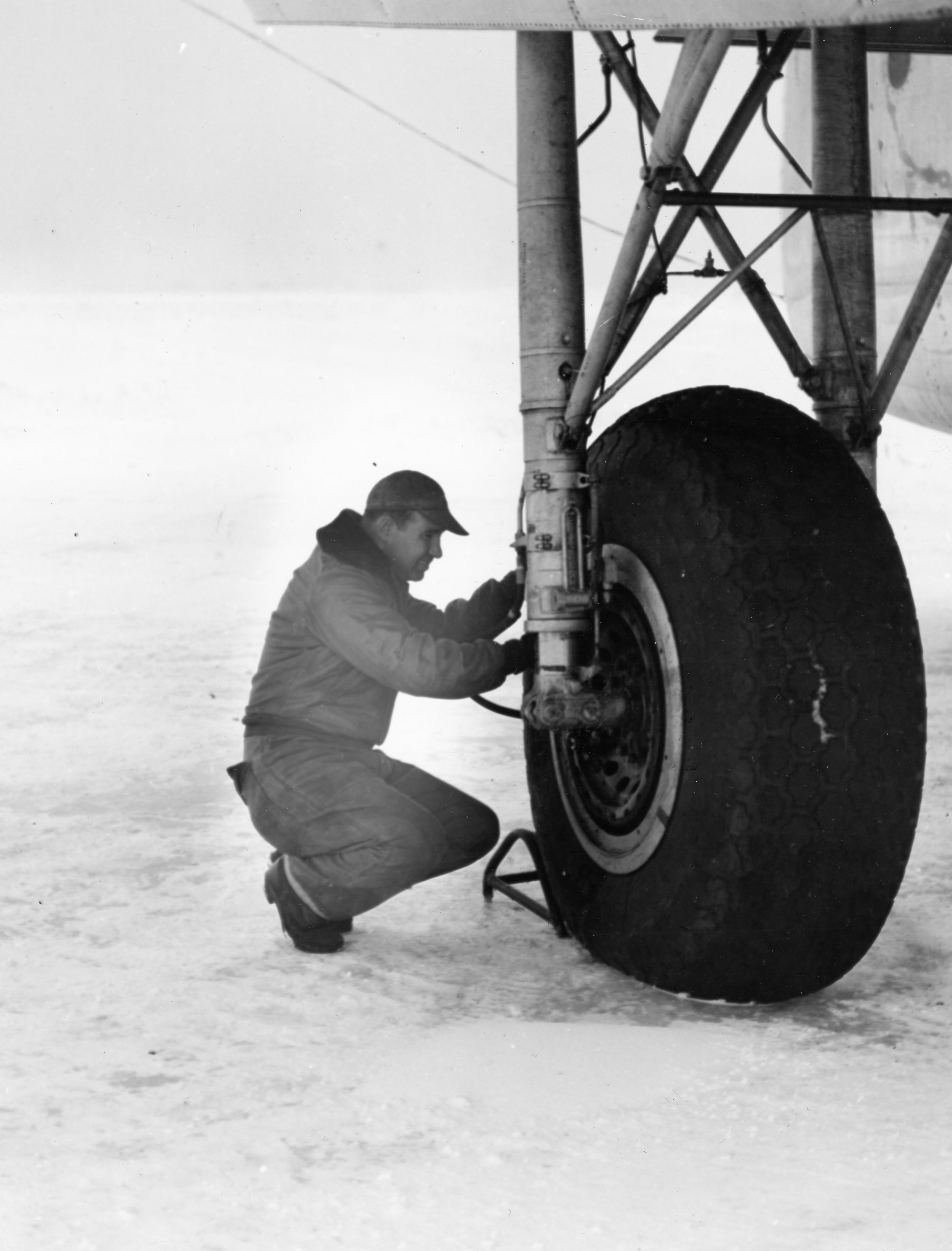 Mechanic working on airplane at Pine Camp in Jefferson County
