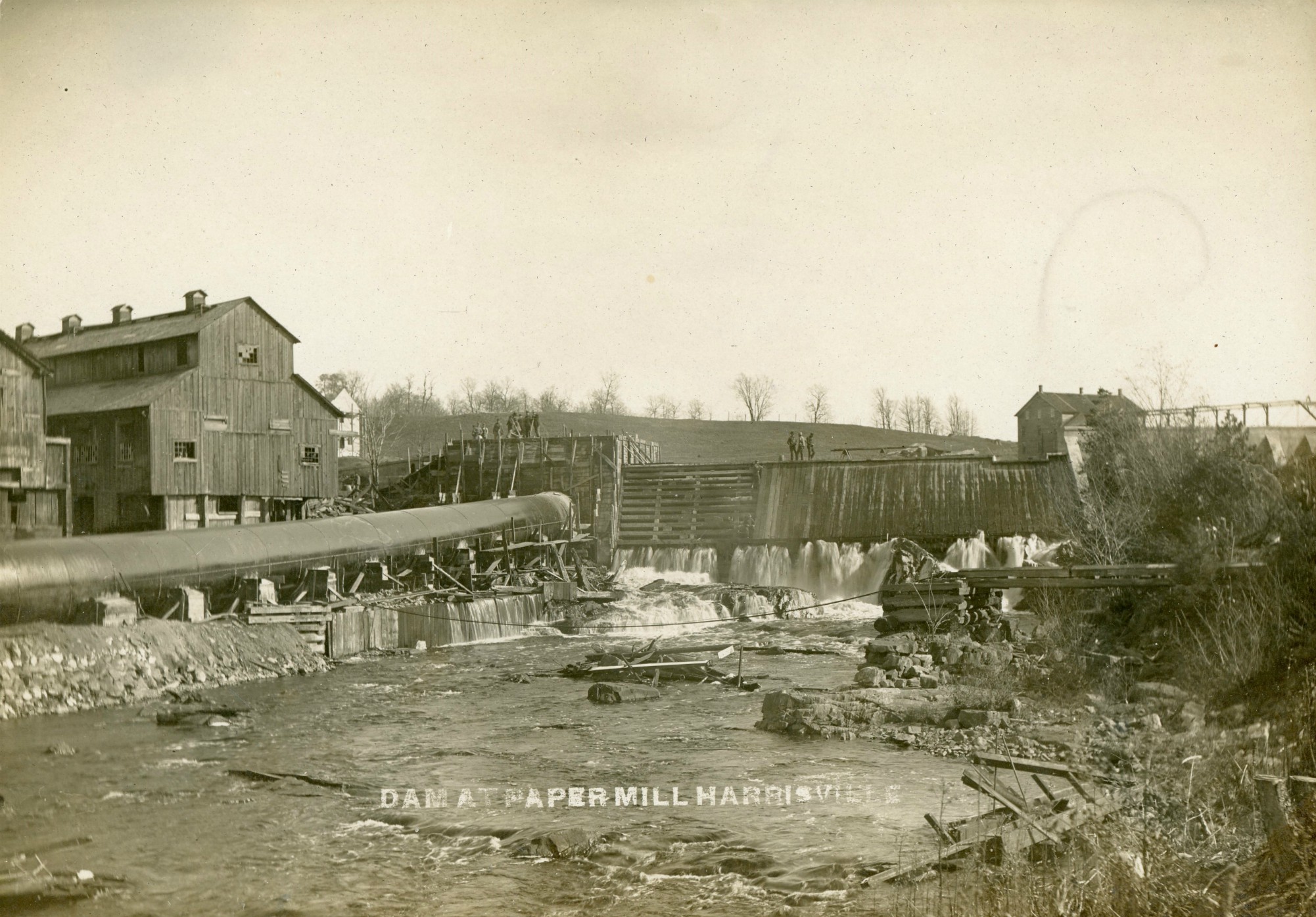 Men repairing the dam at the paper mill in Harrisville