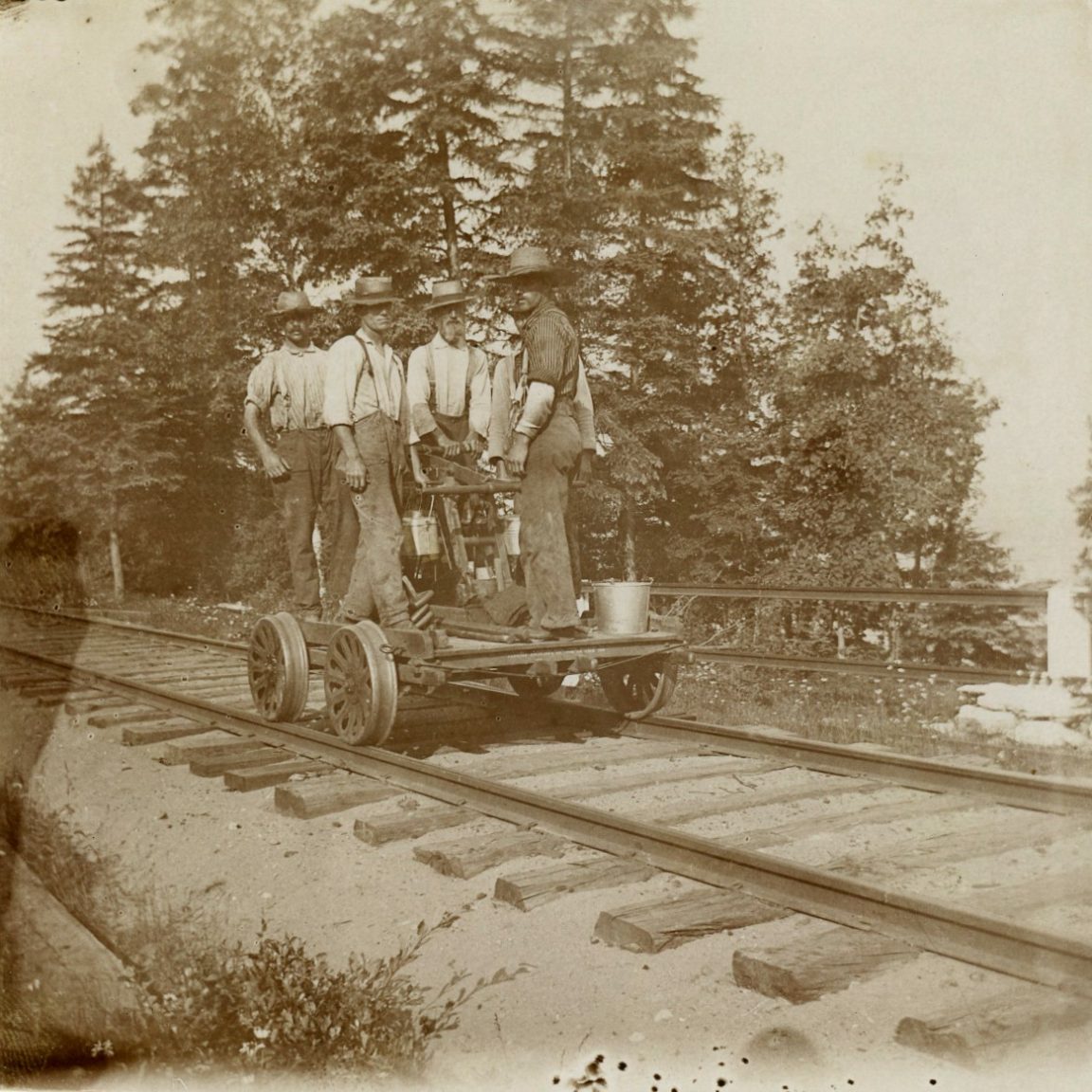 Railroad maintenance workers ride a hand powered pump car in Ogdensburg