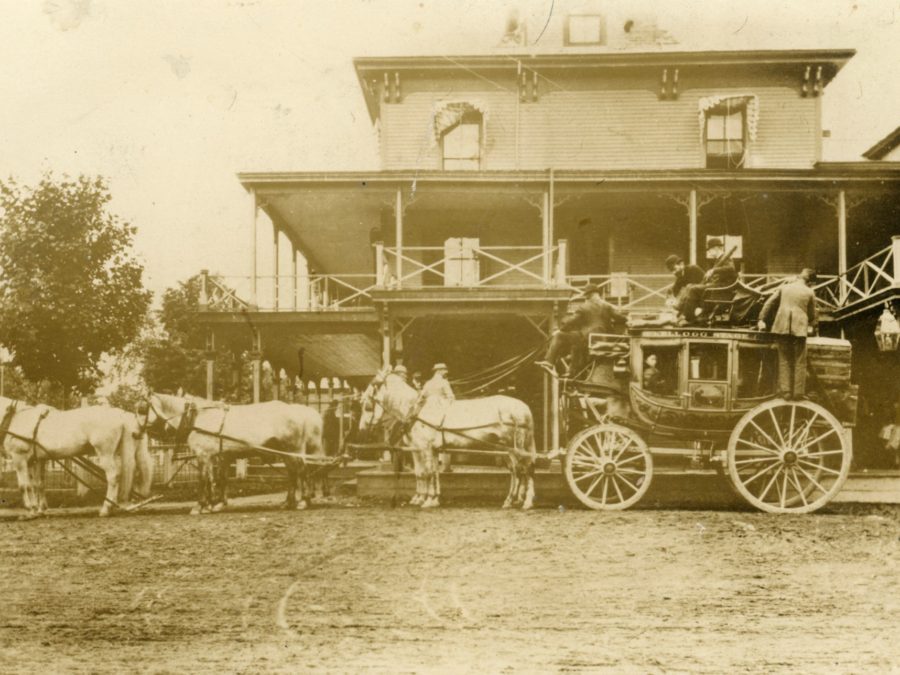 Loaded stagecoach arrives at Stevens House in Lake Placid