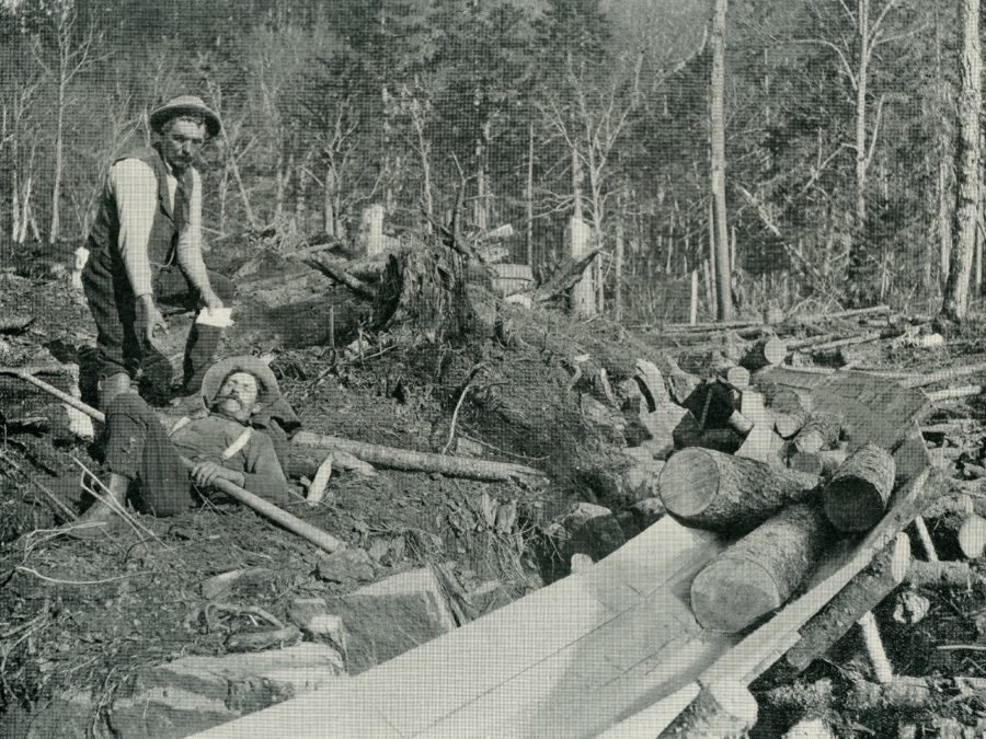 Loggers guide logs into the flume at the Old Forge Dam