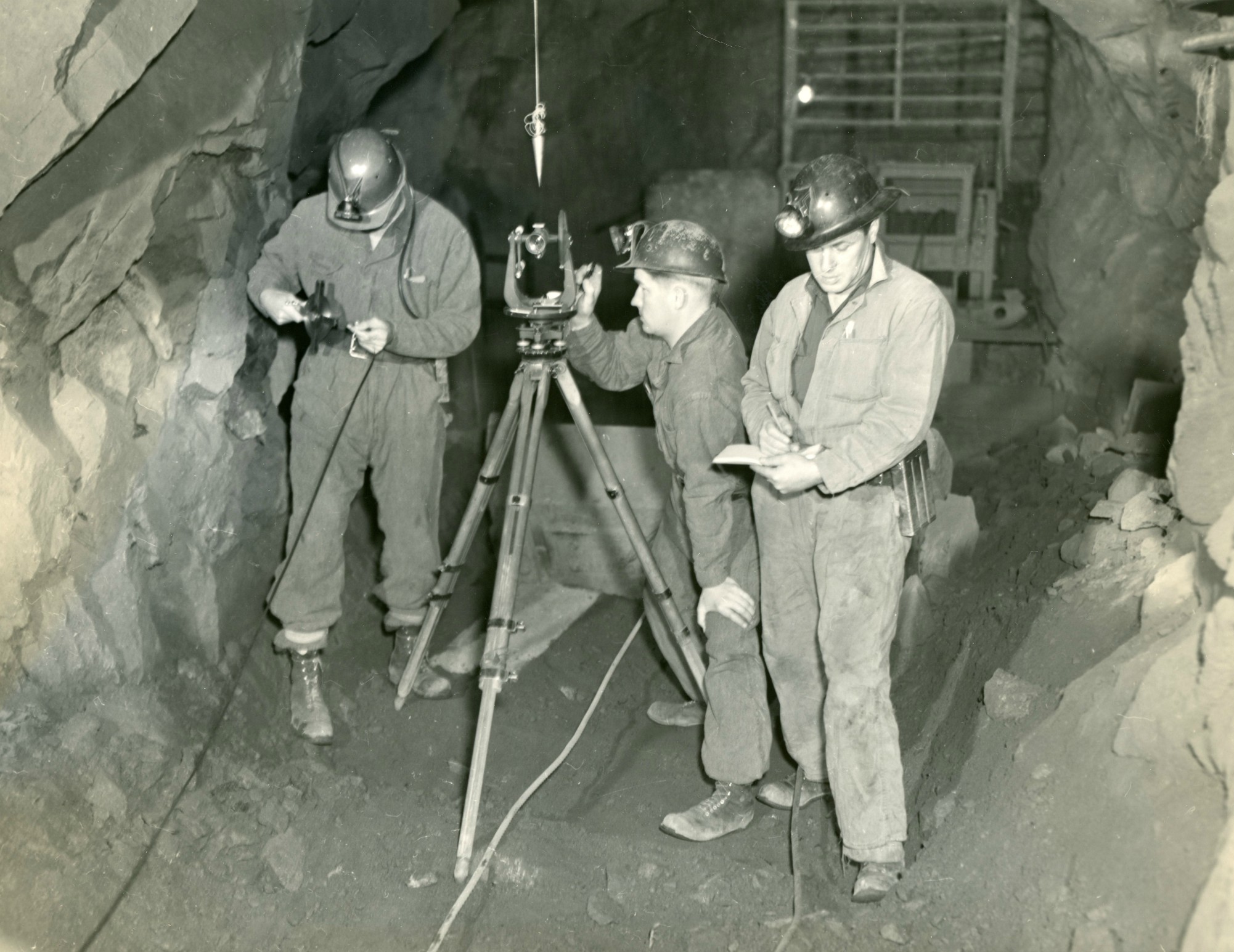 Mining engineers surveying in Republic Steel mine in Mineville