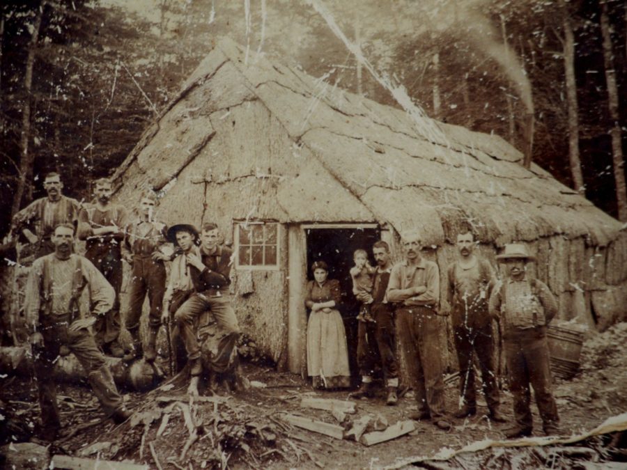 Men and horses at a winter logging camp in the Adirondacks