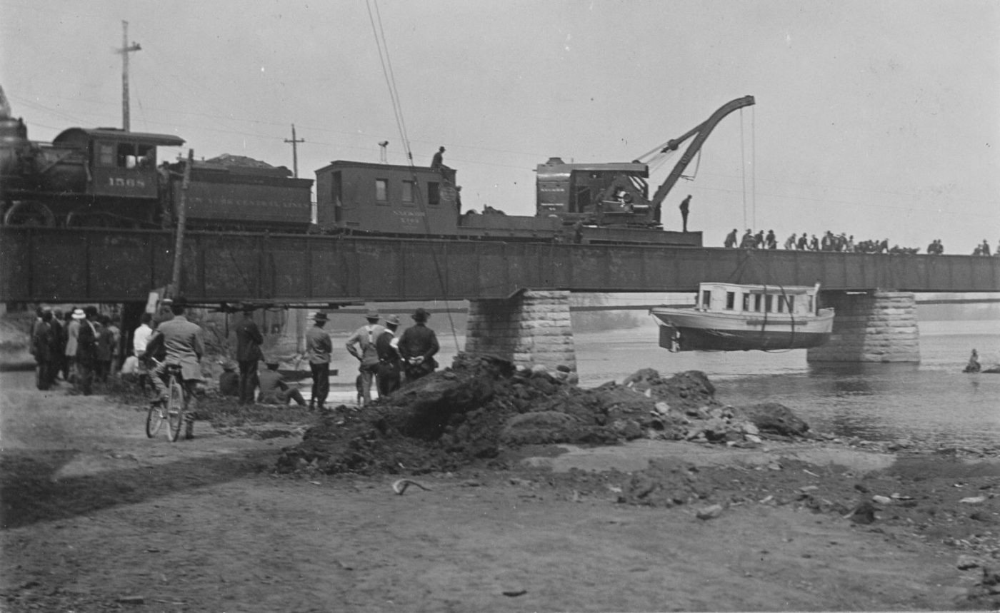 Lowering a logging boat into the Black River in Carthage