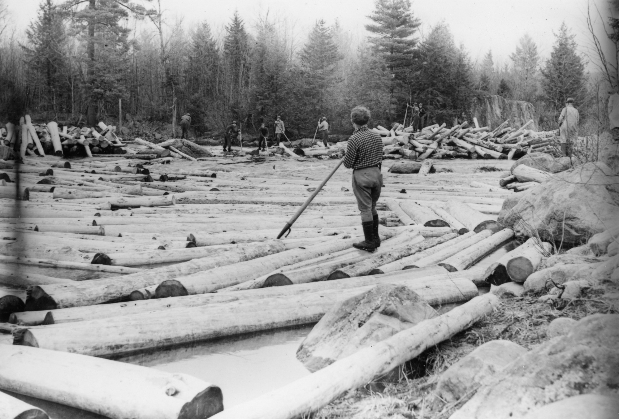 Eight loggers breaking log jam in Town of Webb