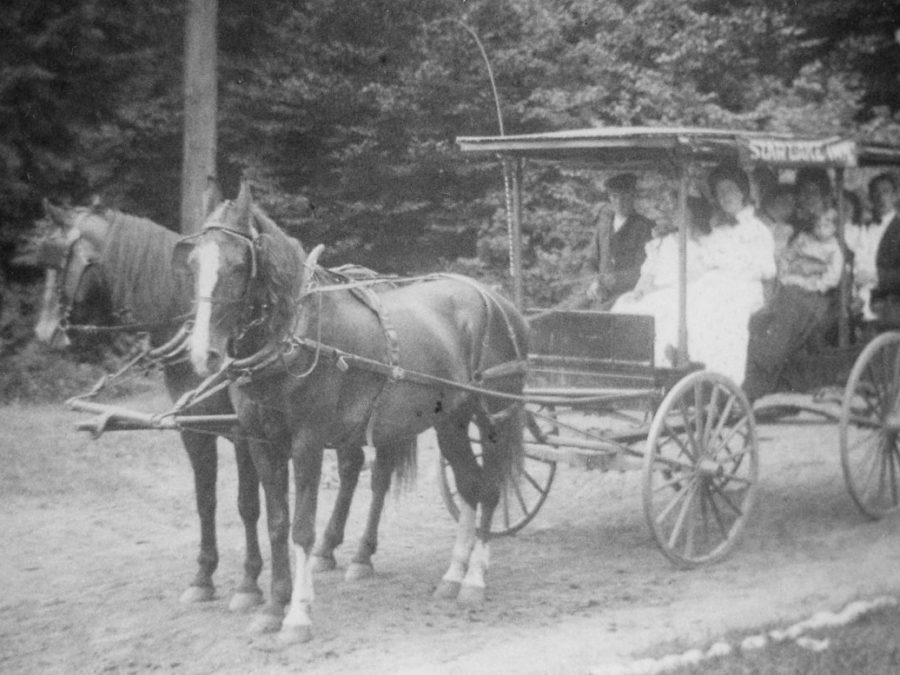 A horse-drawn stagecoach transports passengers on State Street in ...