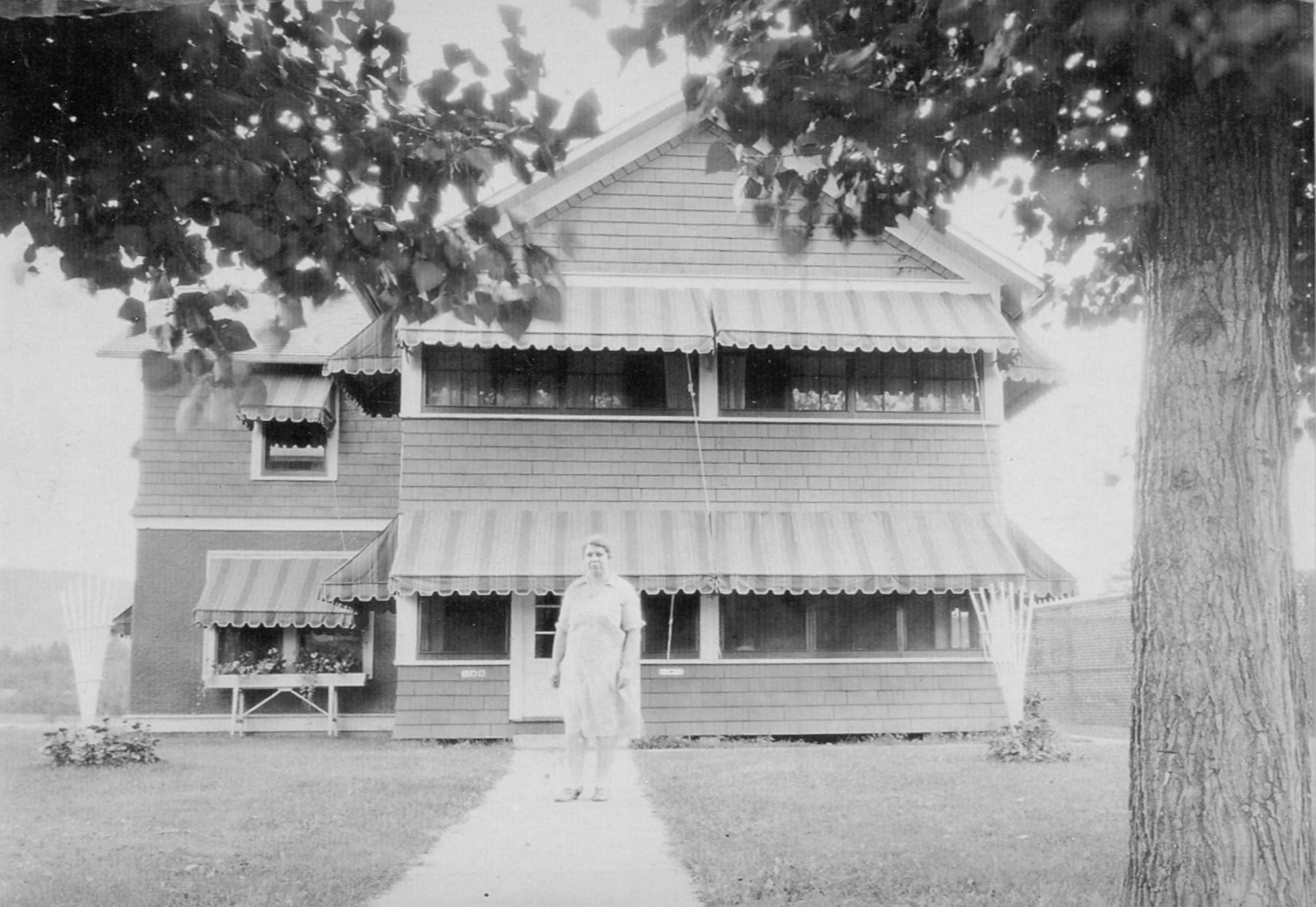 Alice Keough standing in front of her summer motel in Saranac Lake