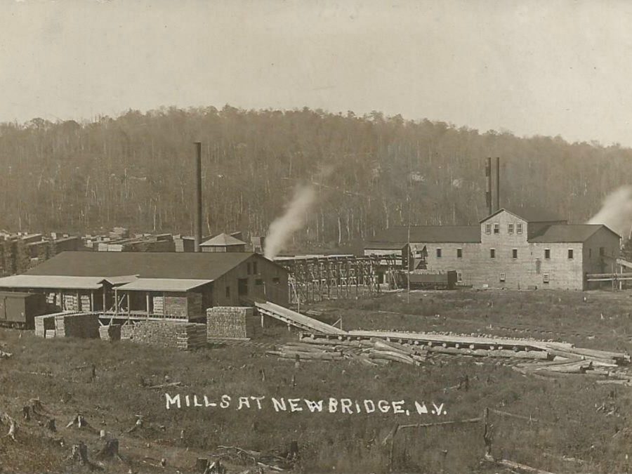 Lumber company workers on steam locomotive in Newbridge