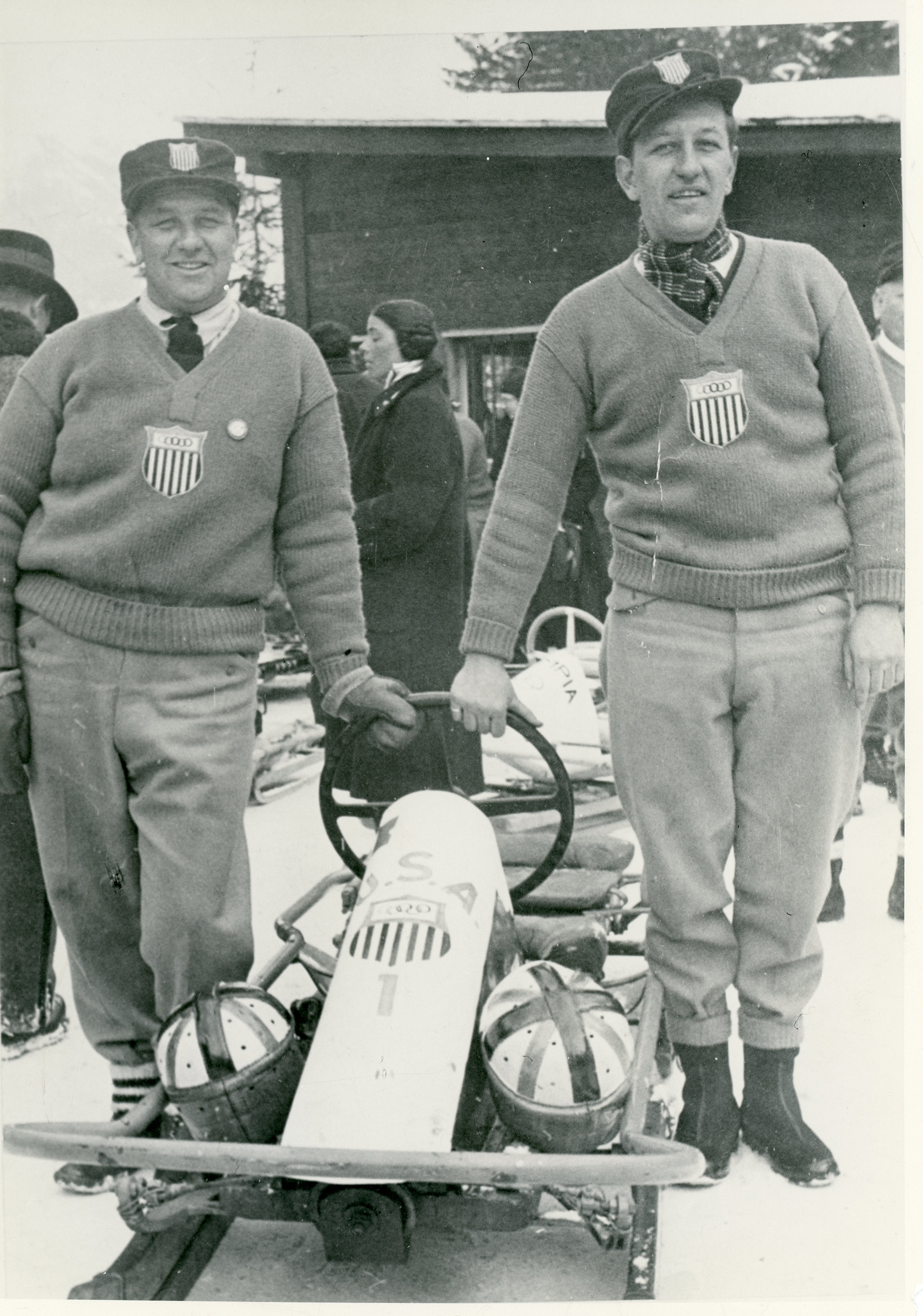 Olympic athletes posing with their bobsled