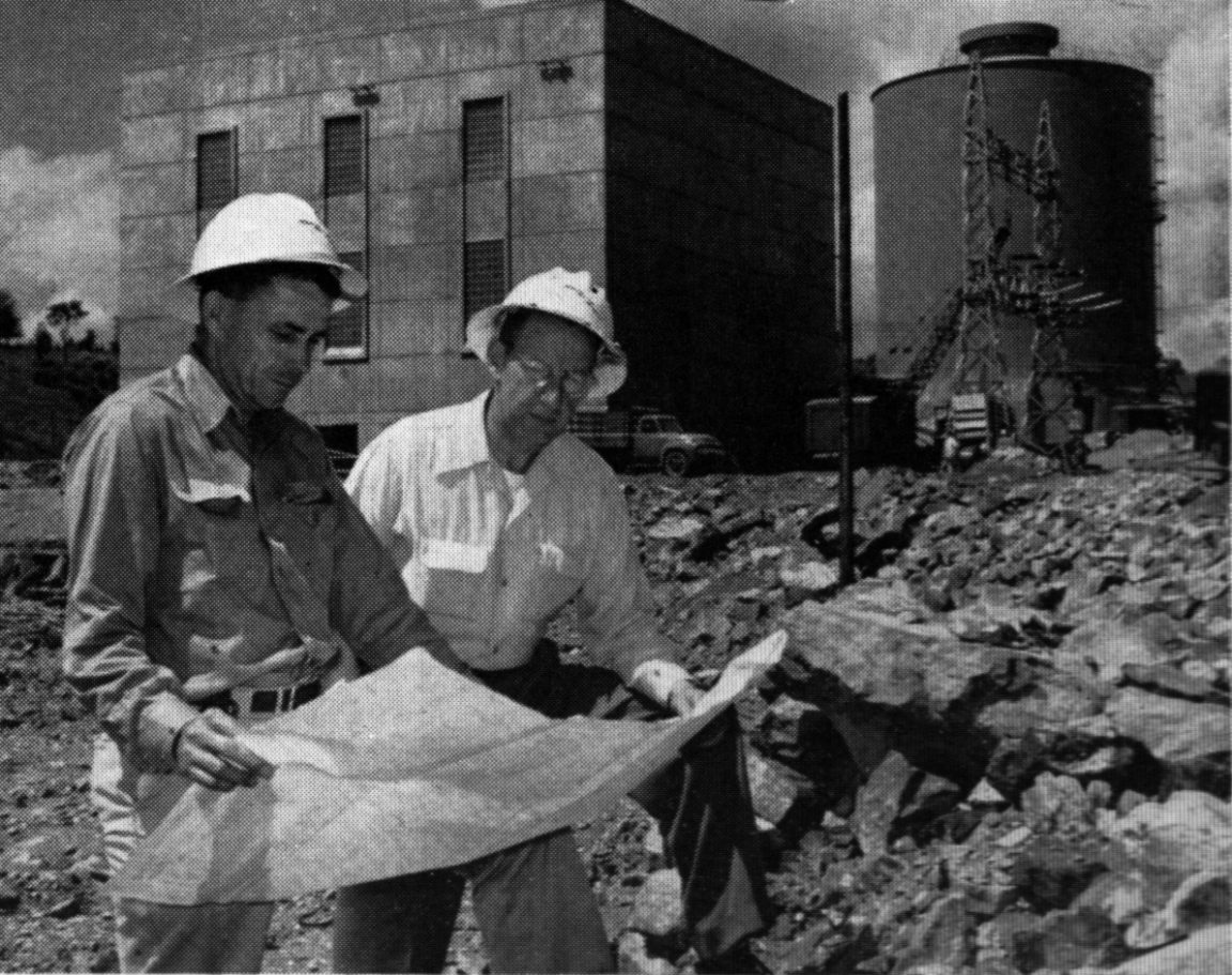 Meryl Morris and Alan Willard anaylzing hydro-electric plant blueprints ...