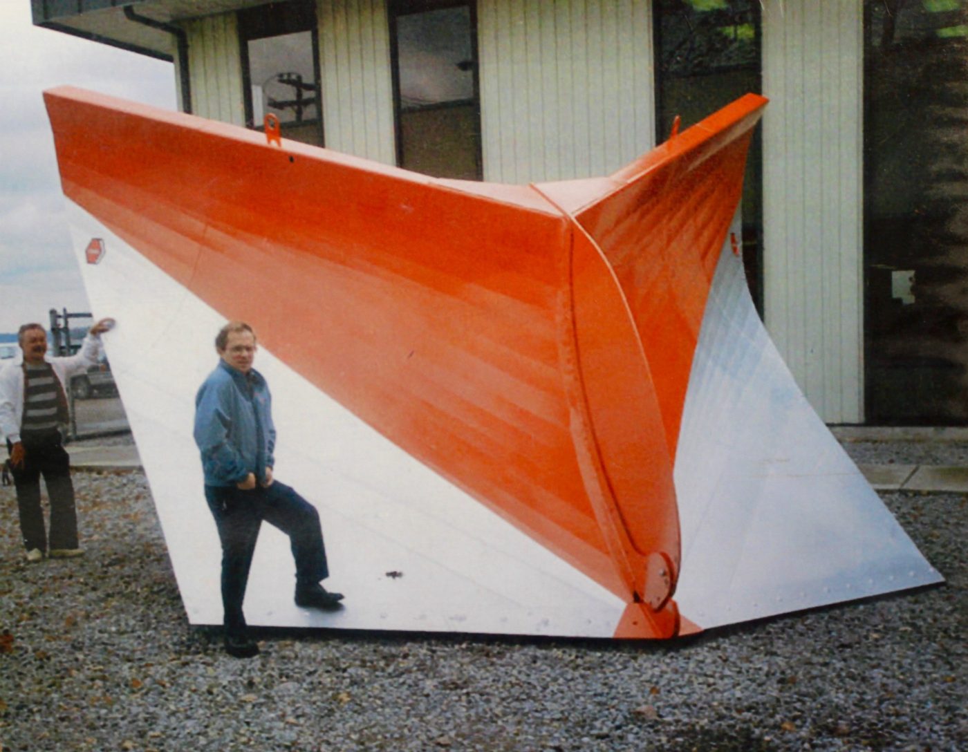 Employees of Frink Snowplows stand next to V-plow in Clayton
