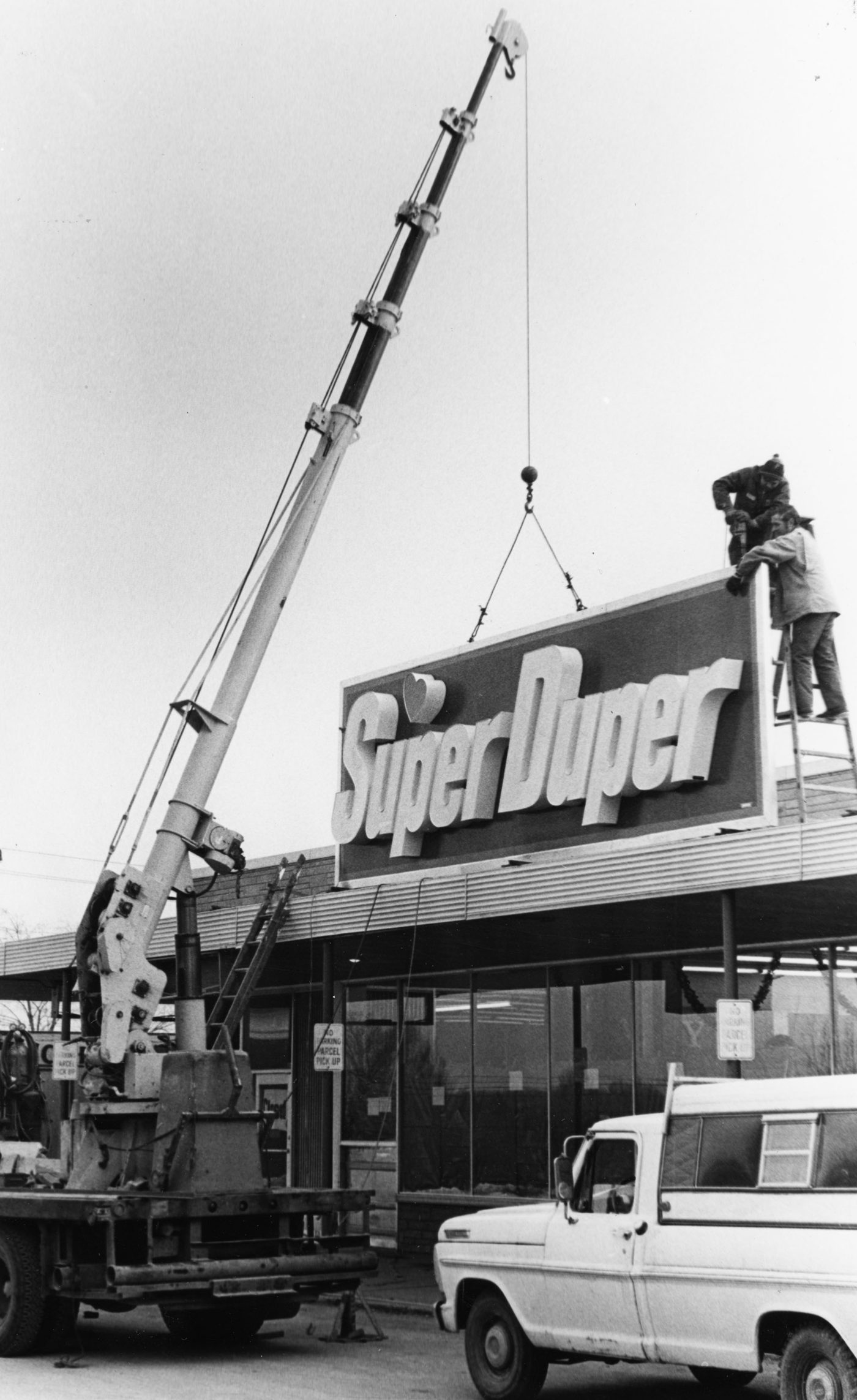 Putting the sign on the Super Duper in West Carthage