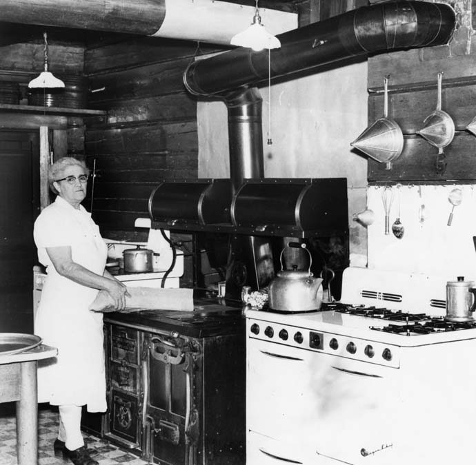 Three men in the kitchen at a logging camp