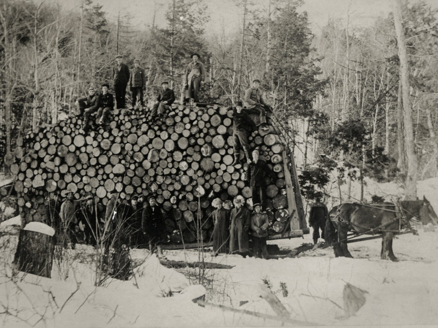 A large load of pulpwood in front of the Spread Eagle Inn in Keene Valley