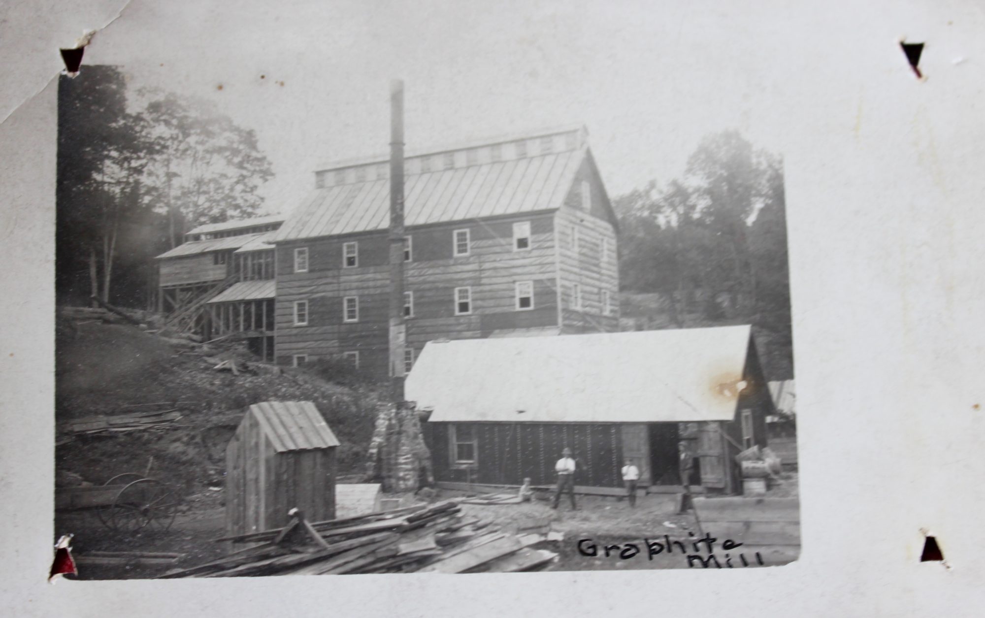 Three workers outside of the Johnsburg Graphite Mill