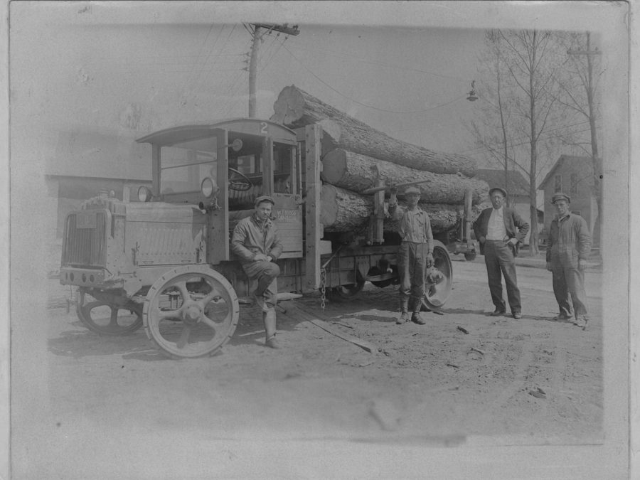 A logging crew pose with a large load of logs in Tupper Lake