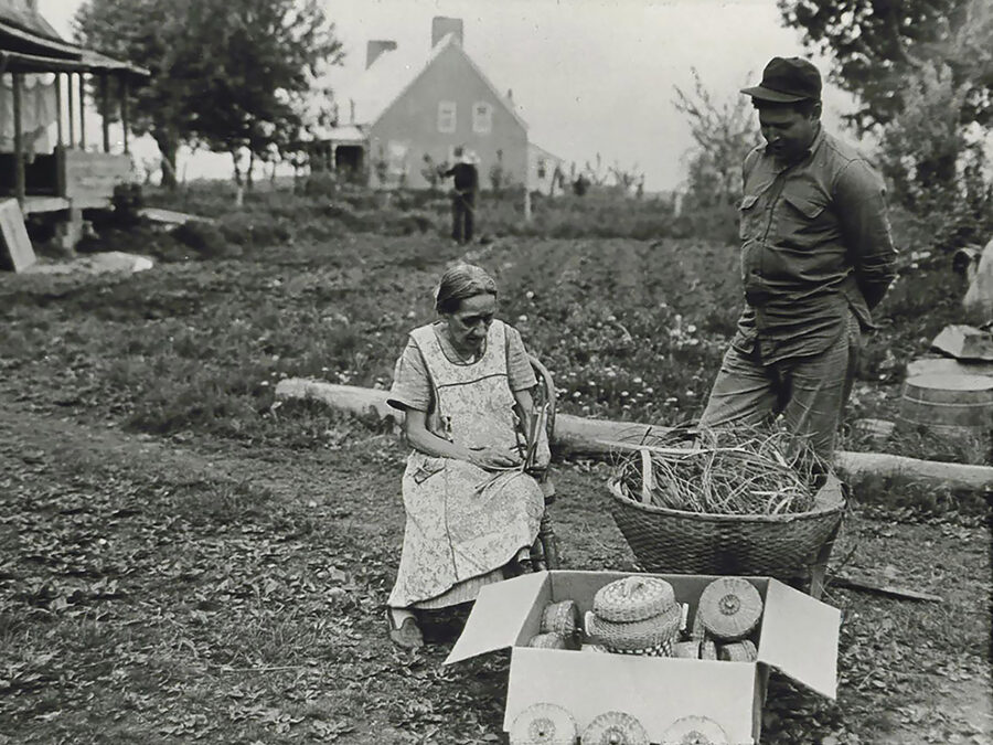 Woman demonstrates basket making technique in Akwesasne