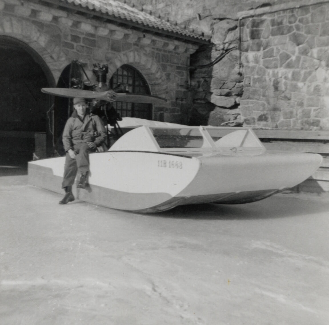 Caretaker Gerald Heath with iceboat at Singer Castle in Chippewa Bay