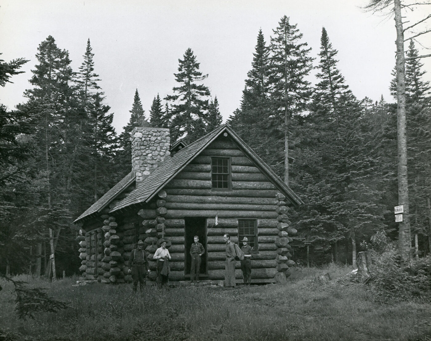 Forest rangers at log cabin in the Town of Newcomb